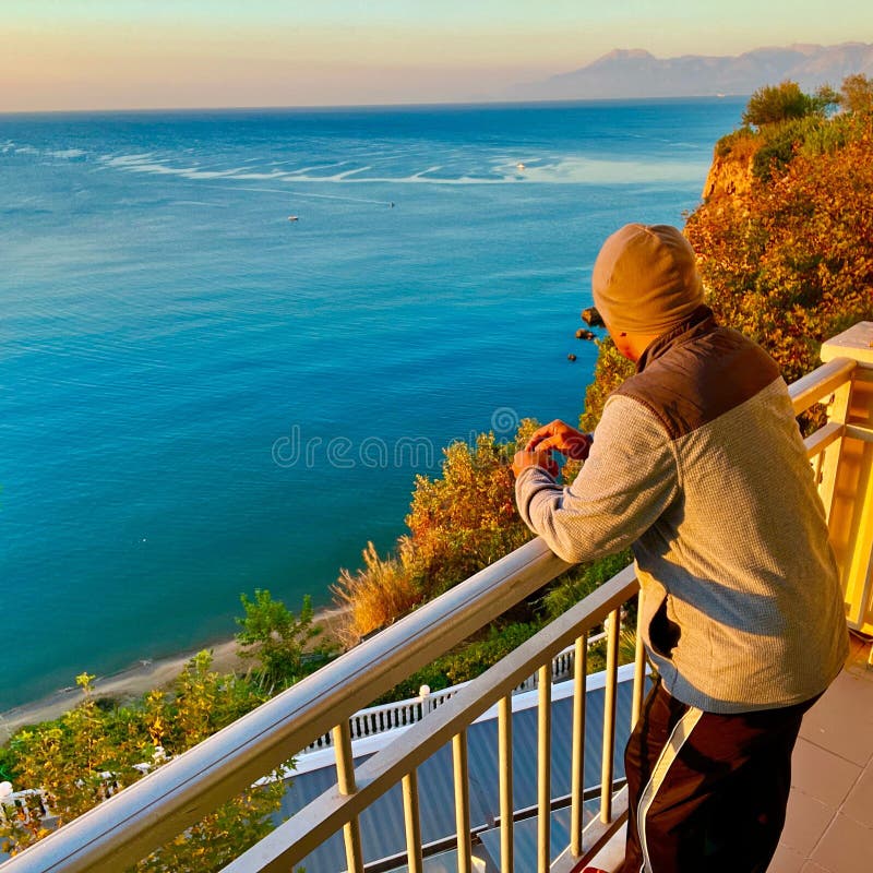 Man Staying in a Seaside Hotel is Viewing a Charming Blue Waterscape ...