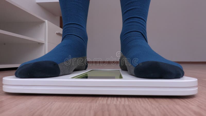 Man Step on Digital Glass Scales To Check Weight. Male Weighting on ...