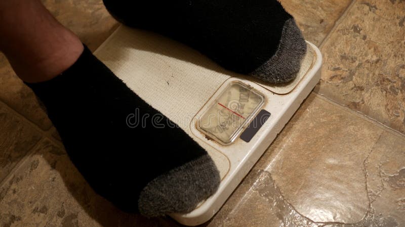 Man Steps on Broken Scale on Bathroom Scale and Weighs Himself - Close ...