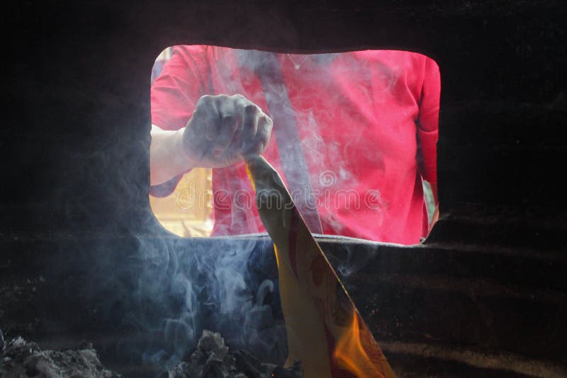 Man stoking fire stock photo. Image of chinese, person - 267212490