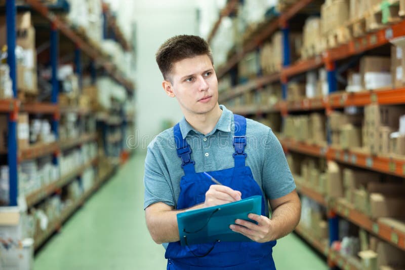Man Storekeeper Keeps Track of Goods on the Shelves of Construction ...