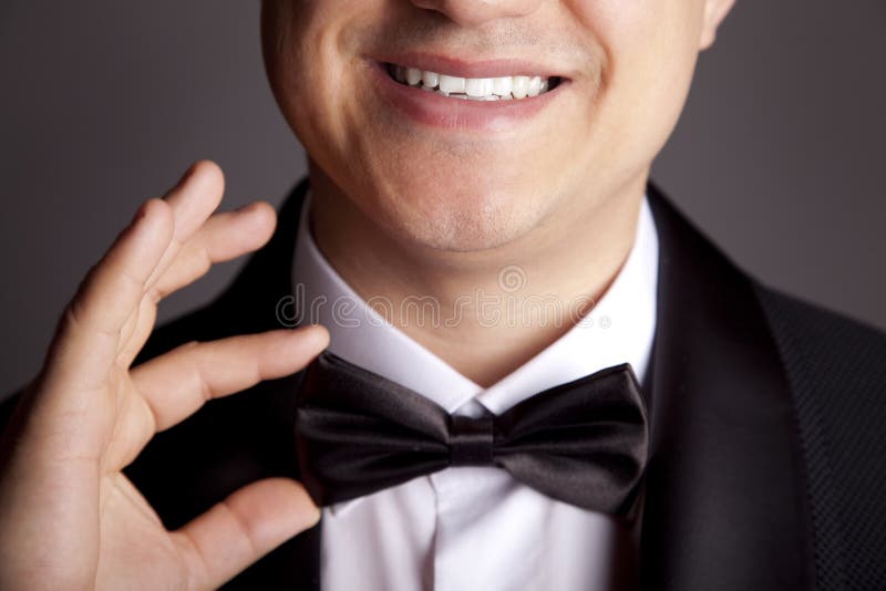 Man straightening his tux. stock photo. Image of face - 22114208