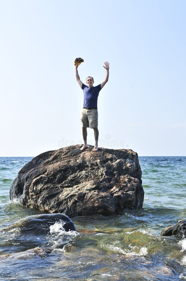 Man Stranded on a Rock in Ocean Stock Photo - Image of adult, middle ...