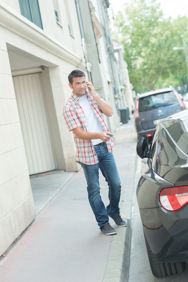 Man on Street Approaching Car Stock Photo - Image of pavement, luxury ...