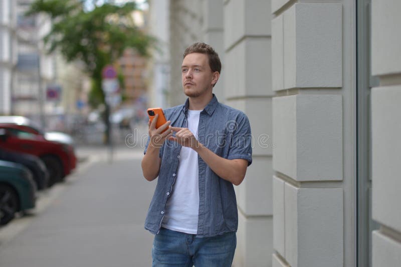 A Man on the Street Using a Smartphone. Concept of Navigating in the ...