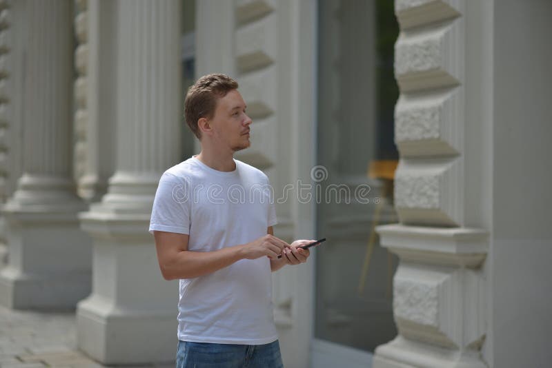 A Man on the Street Using a Smartphone. Concept of Navigating in the ...