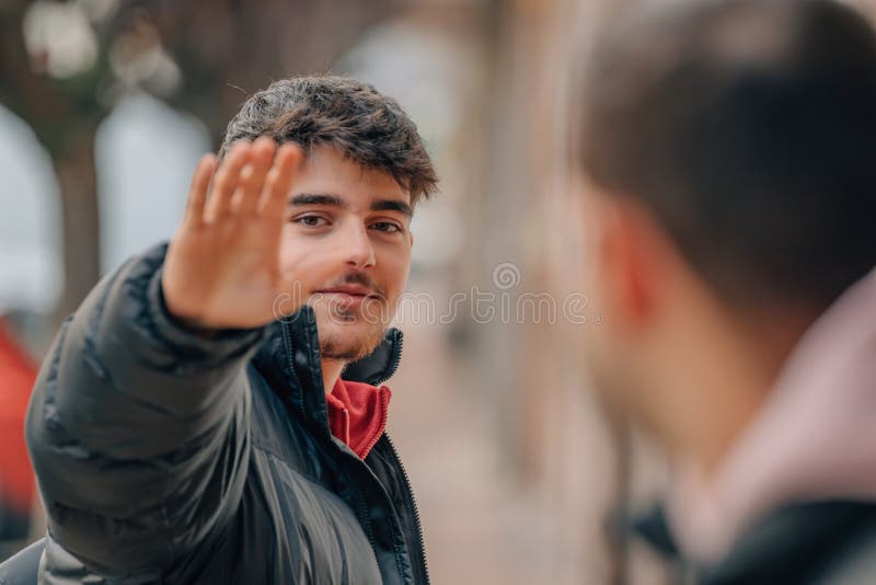 Man in the street waving stock image. Image of outside - 266148201