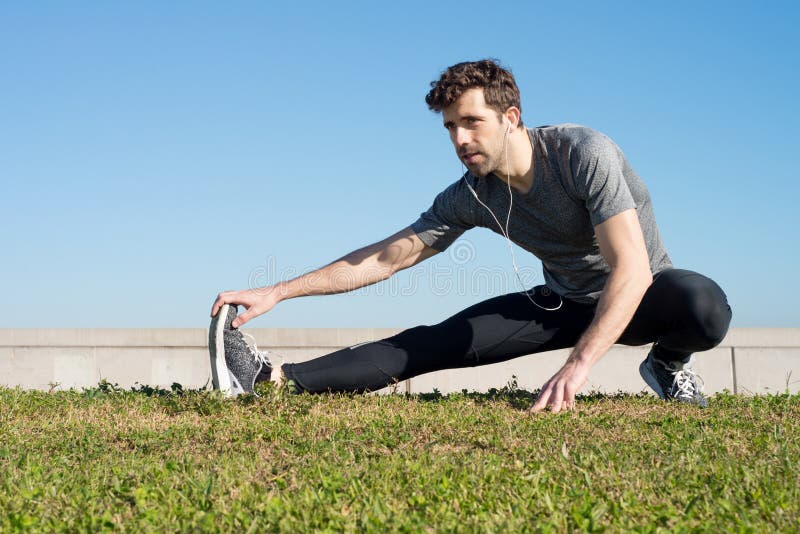 Man stretches leg stock image. Image of earpieces, space - 63459575