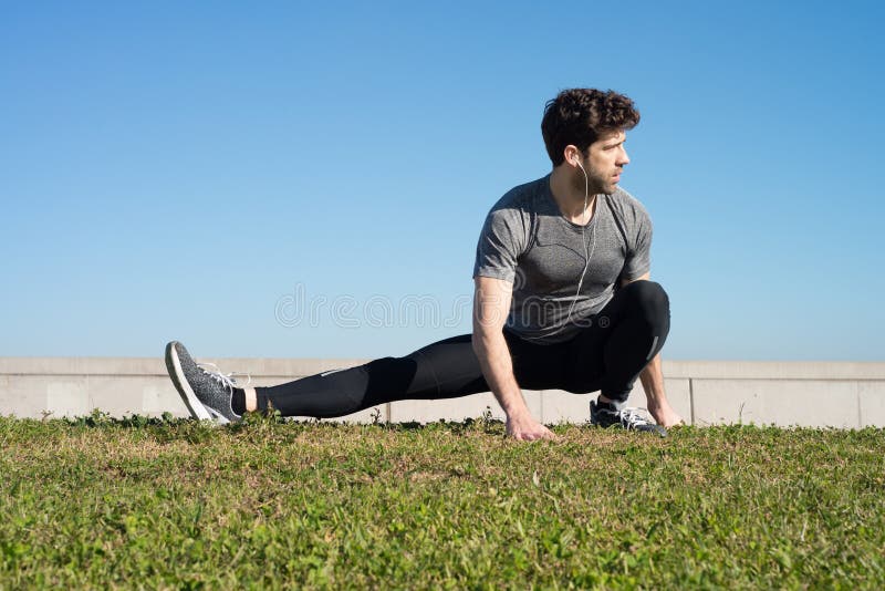 Man Stretches Leg in the Ground Stock Photo - Image of stretching ...