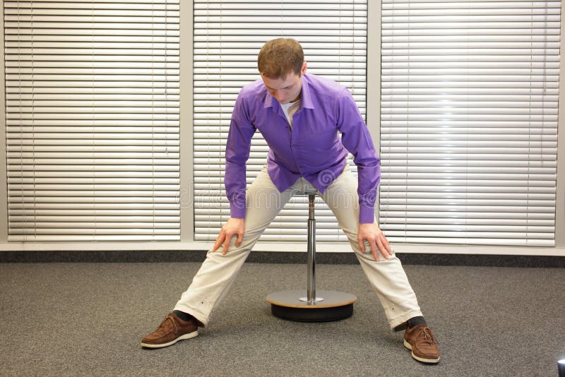 Stretching Legs in Office - Man Sitting on Pneumatic Stool Exercising ...