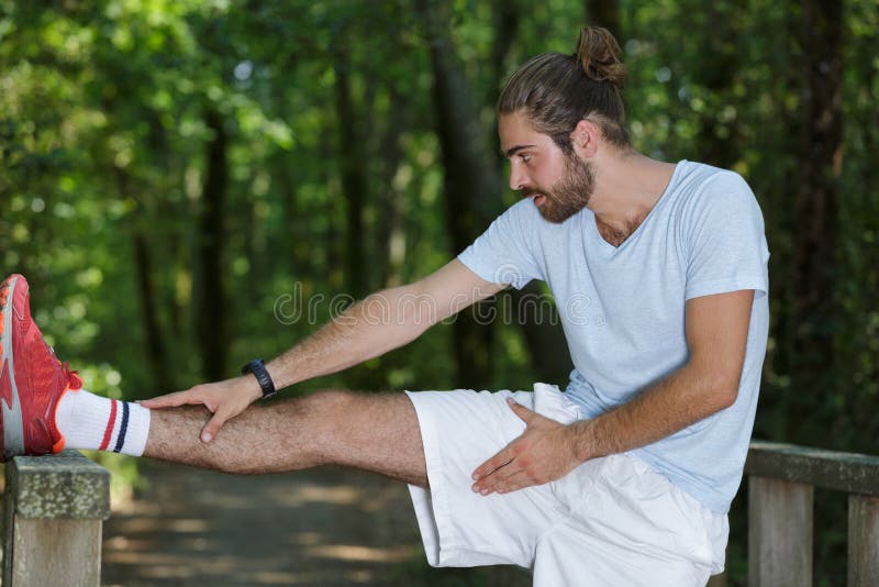 Man Stretching Legs on Bench Stock Photo - Image of sportsman, athlete ...