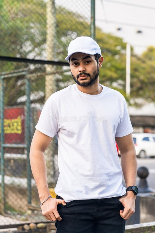 A Man Strikes a Commanding Pose in a White Blank Shirt and Cap Hat ...