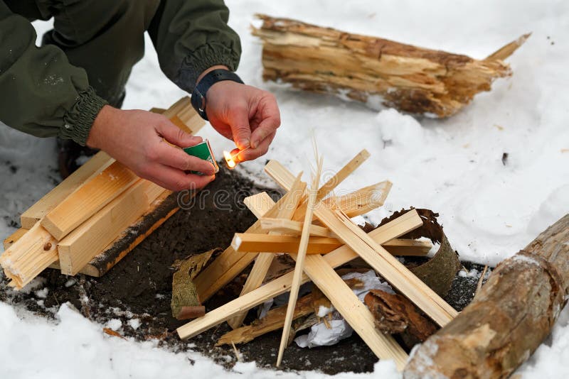 A Man Strikes a Match To Make a Fire. Stock Image - Image of firewood ...