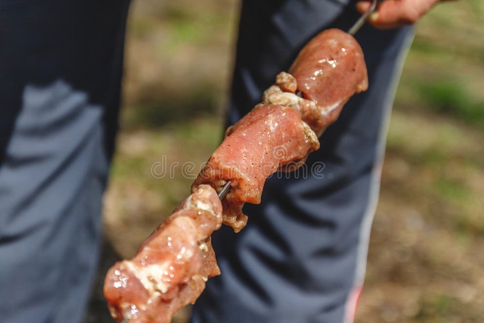 Man Stringing Meat on a Skewer. Close-up. Stock Image - Image of ...