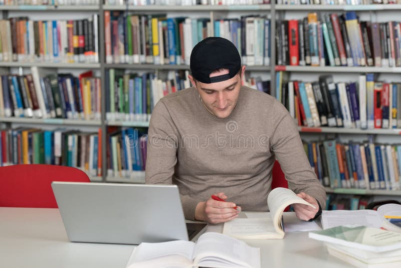 Student with Cap on Head Learning in Library Stock Photo - Image of ...