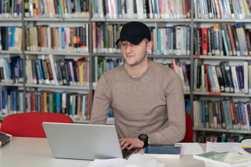 Student with Cap on Head Learning in Library Stock Photo - Image of ...