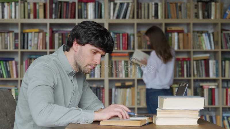 Man Student Preparing Exam and Learning Lessons in Library. Young Man ...