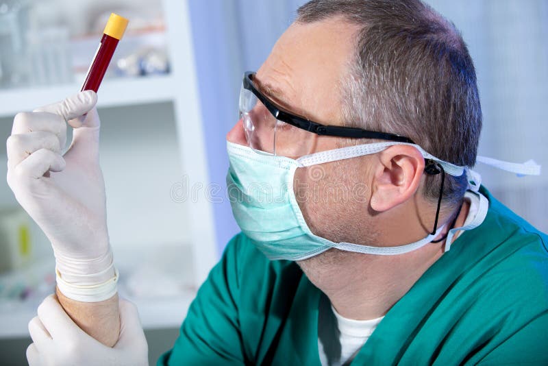 Man Studying Liquid Sample Contained in a Test-tube Stock Image - Image ...