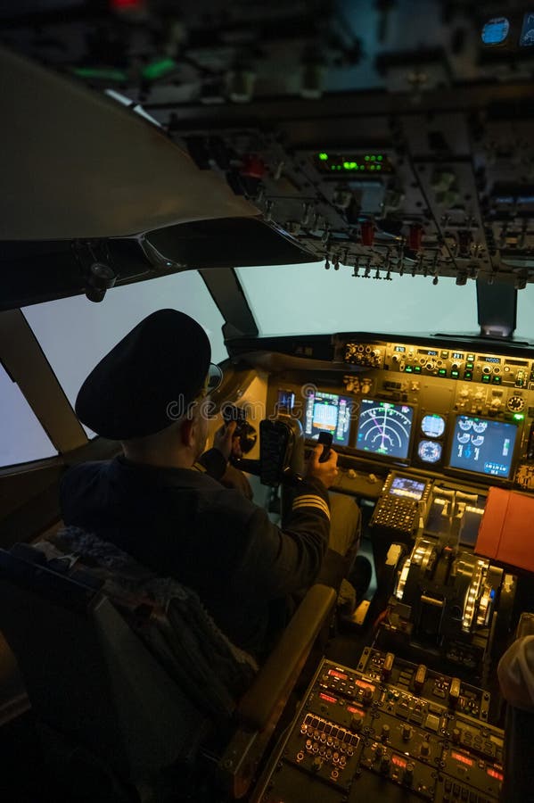 A Man is Studying To Be a Pilot in an Aircraft Simulator. Stock Image ...
