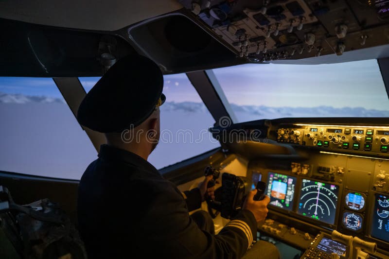 A Man is Studying To Be a Pilot in an Aircraft Simulator. Stock Photo ...