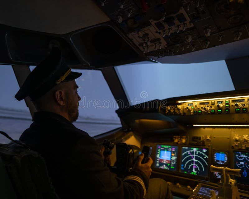 A Man is Studying To Be a Pilot in an Aircraft Simulator. Stock Photo ...