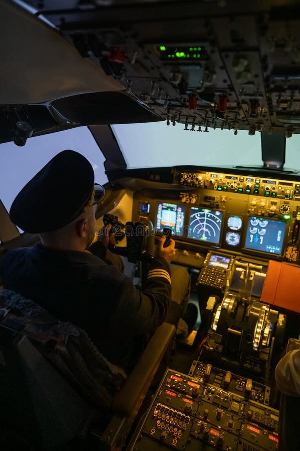 A Man is Studying To Be a Pilot in an Aircraft Simulator. Stock Photo ...