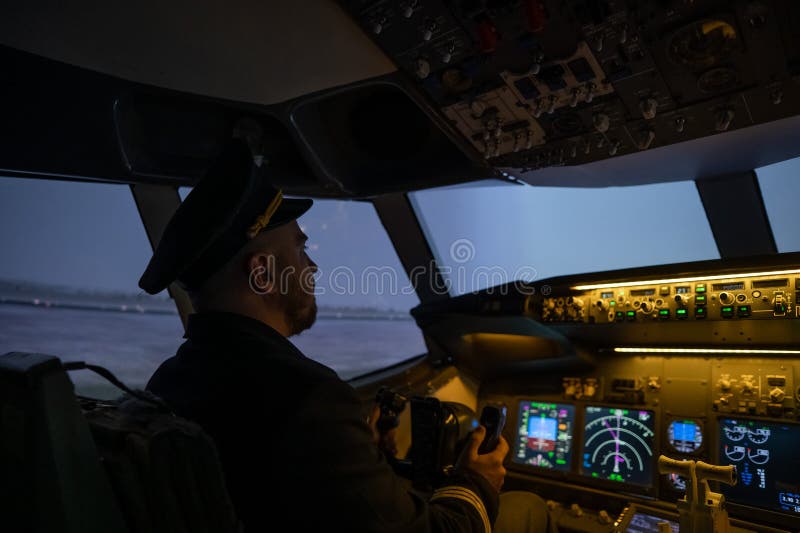 A Man is Studying To Be a Pilot in an Aircraft Simulator. Stock Image ...