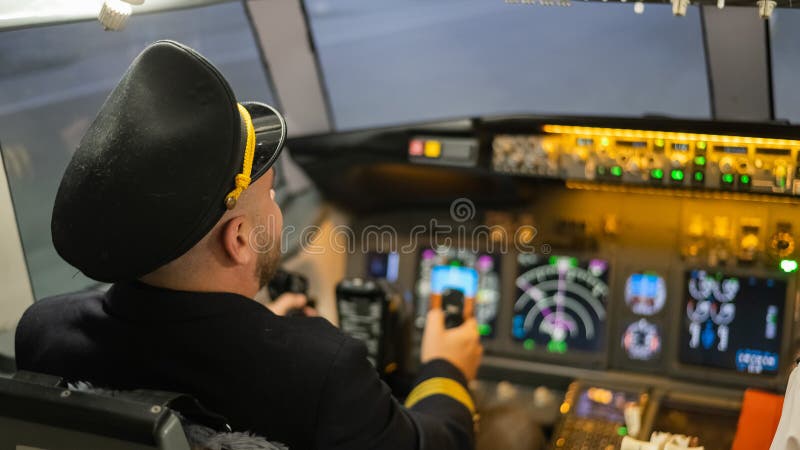 A Man is Studying To Be a Pilot in an Aircraft Simulator. Stock Image ...