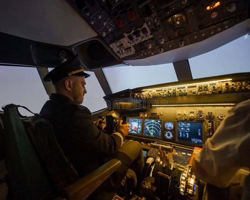 A Man is Studying To Be a Pilot in an Aircraft Simulator. Stock Photo ...