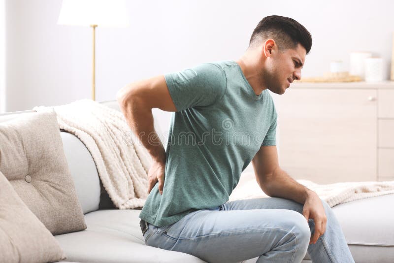 Man Suffering from Back Pain at Home. Bad Posture Problem Stock Image ...