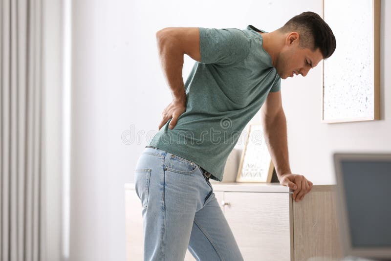 Man Suffering from Back Pain at Home. Bad Posture Problem Stock Photo ...