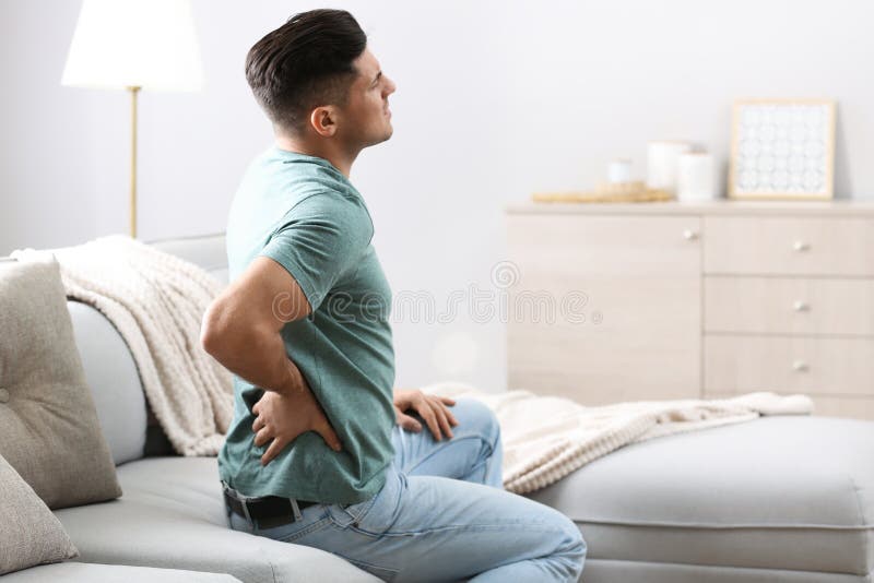 Man Suffering from Back Pain at Home. Bad Posture Problem Stock Image ...