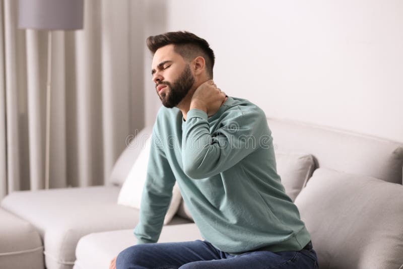 Man Suffering from Back Pain at Home. Bad Posture Problem Stock Image ...