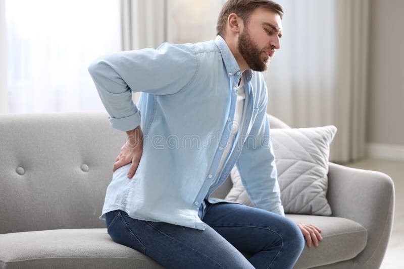 Man Suffering from Back Pain at Home. Bad Posture Problem Stock Photo ...