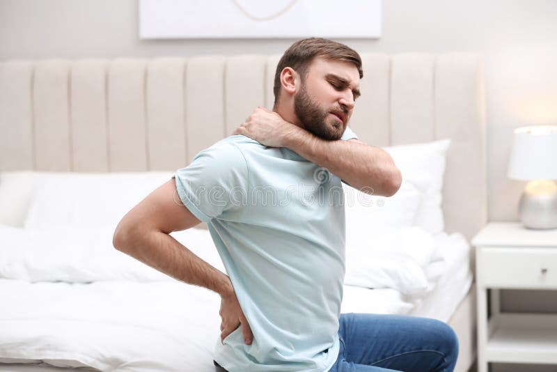 Man Suffering from Back Pain at Home. Bad Posture Problem Stock Image ...