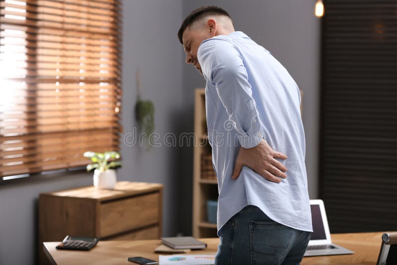 Man Suffering from Back Pain in Office. Symptom of Poor Posture Stock ...