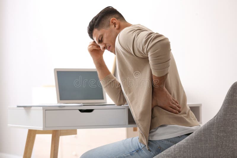 Man Suffering from Back Pain at Workplace. Bad Posture Problem Stock ...