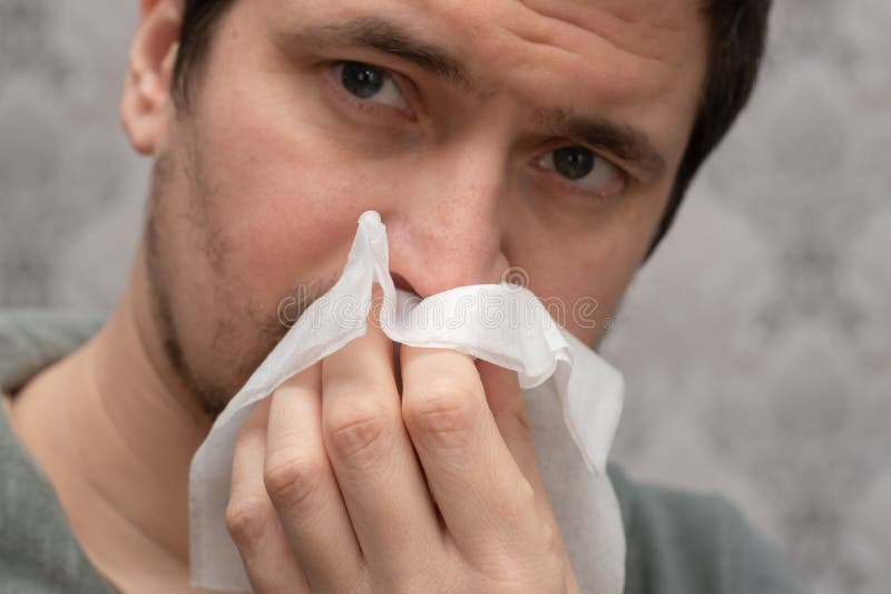 Man Suffering from a Cold and Runny Nose Using a Tissue Stock Photo ...