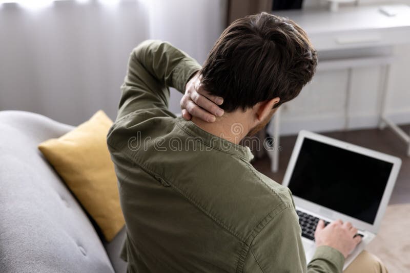 Man Suffering Neck Pain while Working on Laptop at Home Stock Image ...