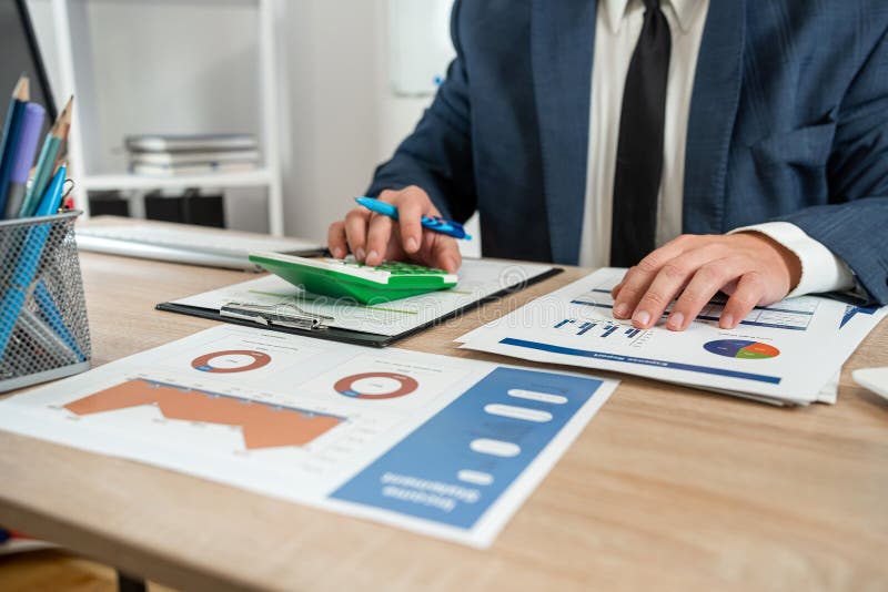 Man in Suit Doing Annual Report Analysis Data the Charts and Graphs at ...