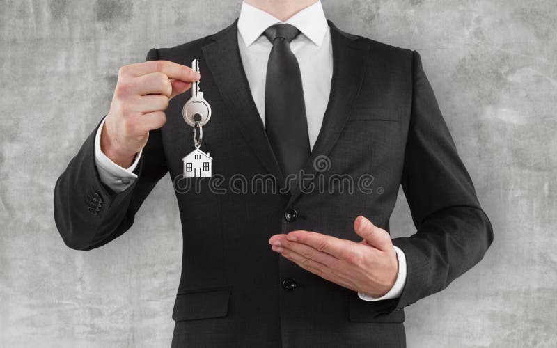 Man in suit gives a key stock photo. Image of modern - 38113094