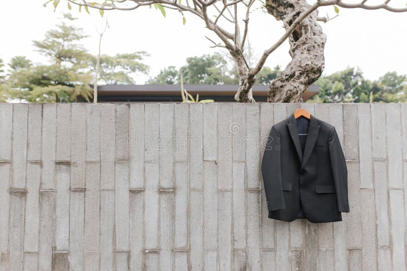 A Man Suit Hanging on an Outdoor Wall Stock Image - Image of event ...