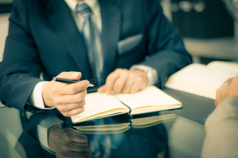 Man in a Suit Holding a Pen and Taking Notes Stock Image - Image of ...