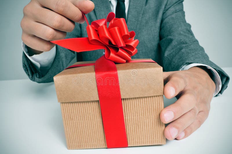 Man in suit opening a gift stock image. Image of birthday - 35528687