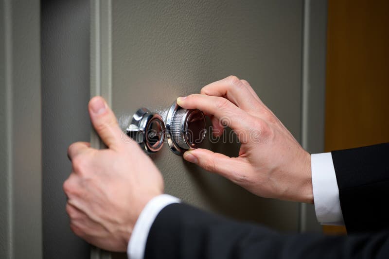 A Man in a Suit is Opening Safe by Turning the Combination Lock. Ai ...