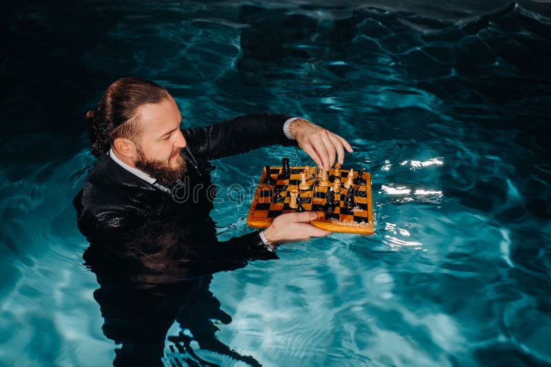 A Man in a Suit Plays Chess on the Water in the Pool Stock Image ...
