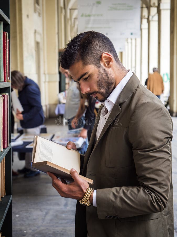 Man in suit reading book stock photo. Image of posing - 101999830