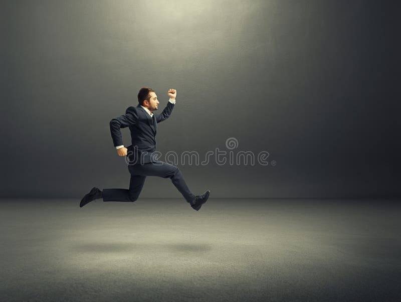 Man in Suit Running Fast in the Dark Room Stock Image - Image of person ...