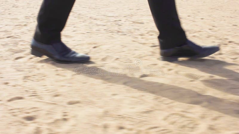 A Man in a Suit and Shoes Rides Along the Beach Stock Video - Video of ...