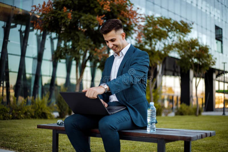 Man in Suit Sitting on Bench with Laptop Stock Photo - Image of ...